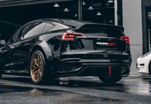 Racing style Tesla Model 3 with fierce body kit and gold rims