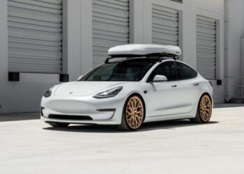 Sporty Touring Tesla Model 3 with Gold Rims and Roof Box - EVMagz