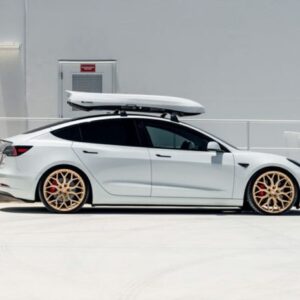 Sporty Touring Tesla Model 3 with Gold Rims and Roof Box